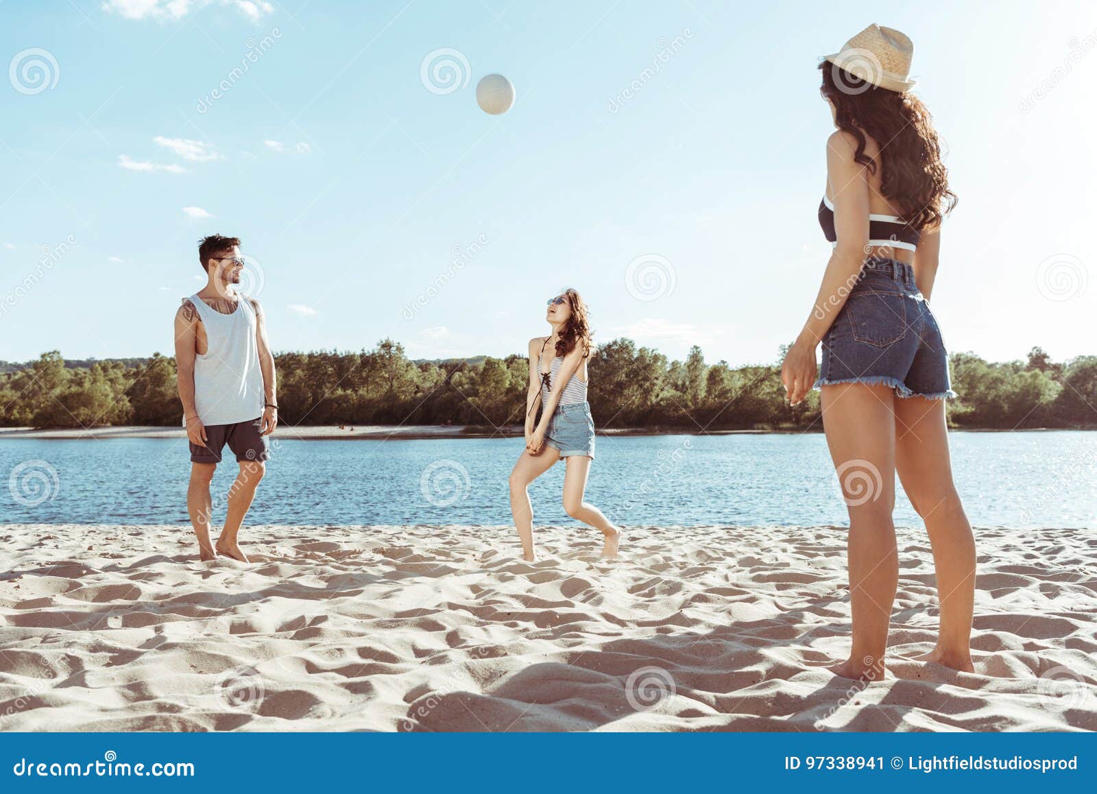 Active Friends Playing Volleyball on Beach Together Stock Image - Image ...