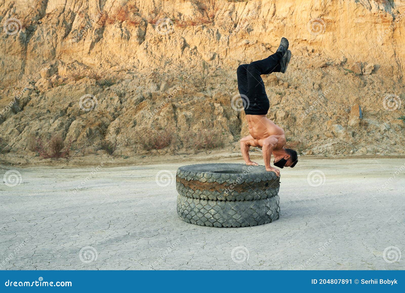 Active Guy Balancing on Tyres while Training Outdoors Stock Image ...