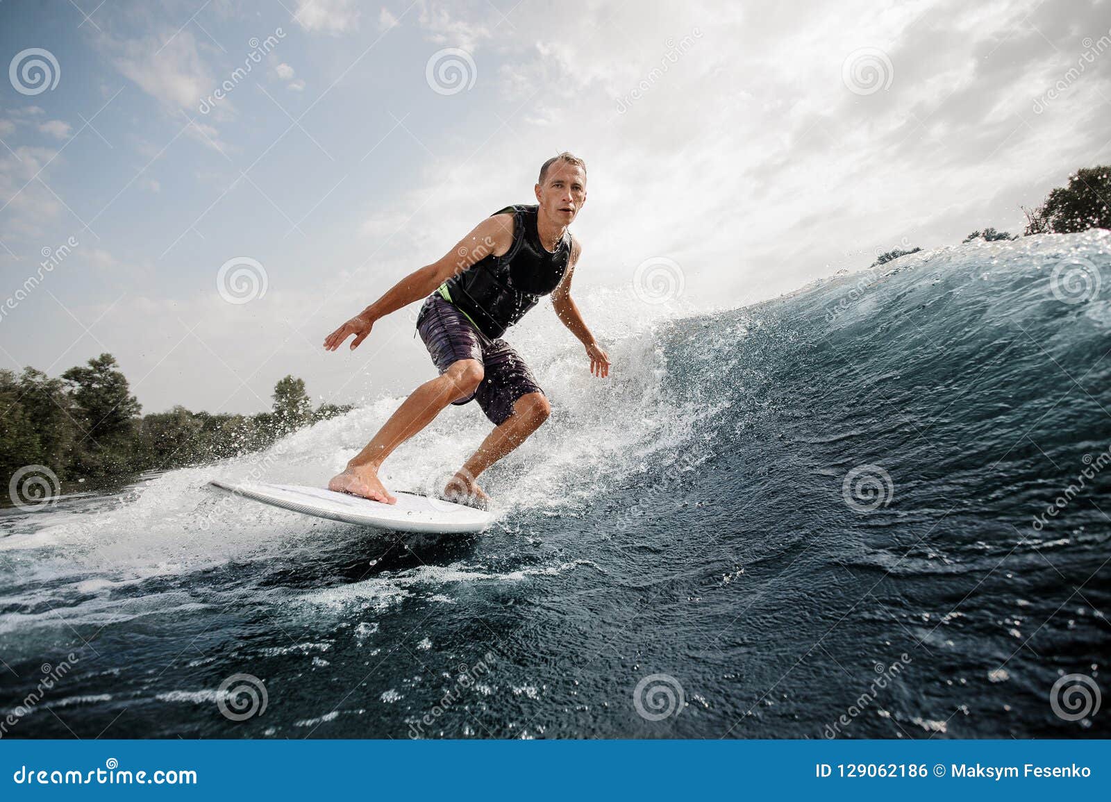 Active Man Riding on the White Wakeboard on the High Wave Stock Photo ...