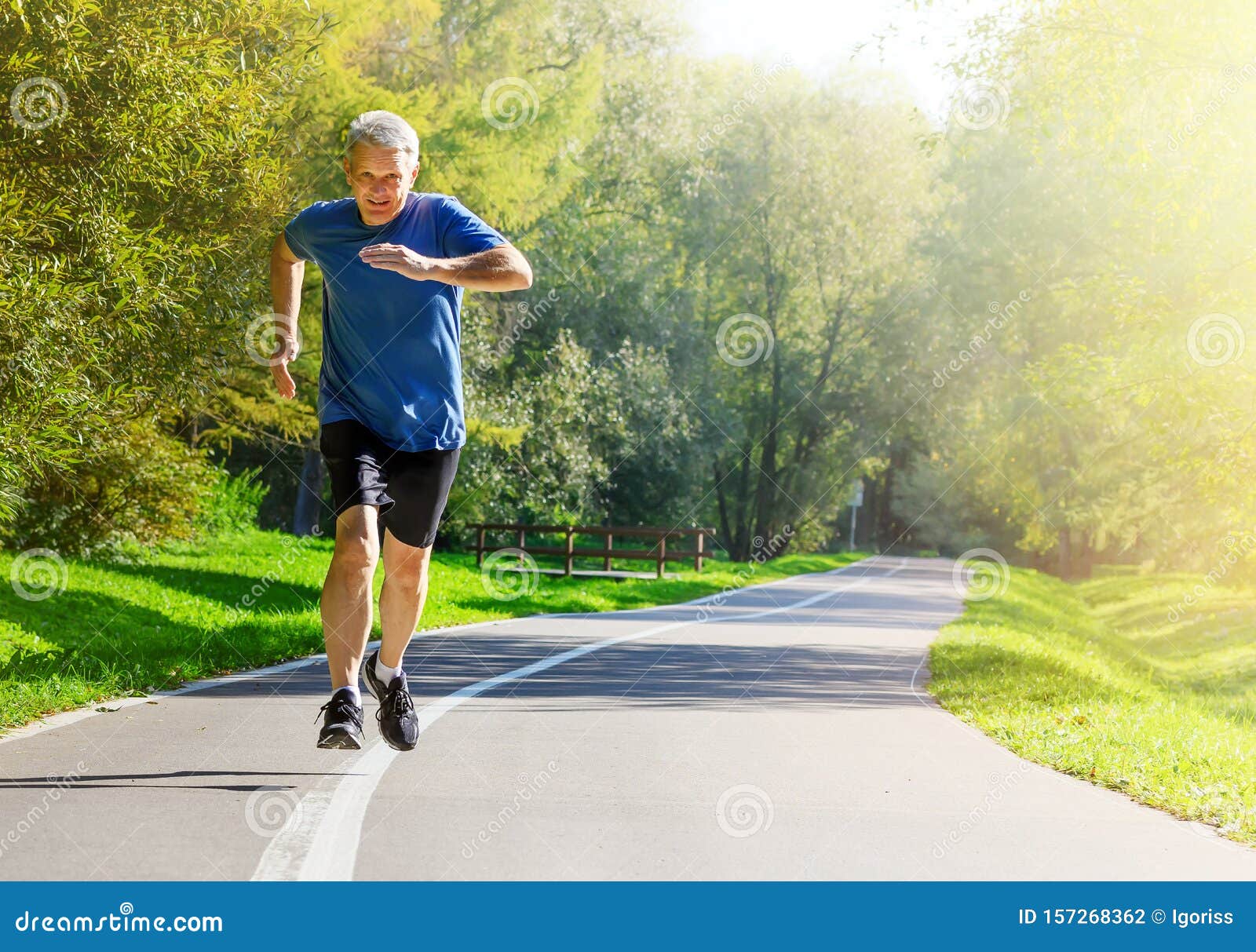Active Middle Aged Man Running in Public Park Stock Photo - Image of ...