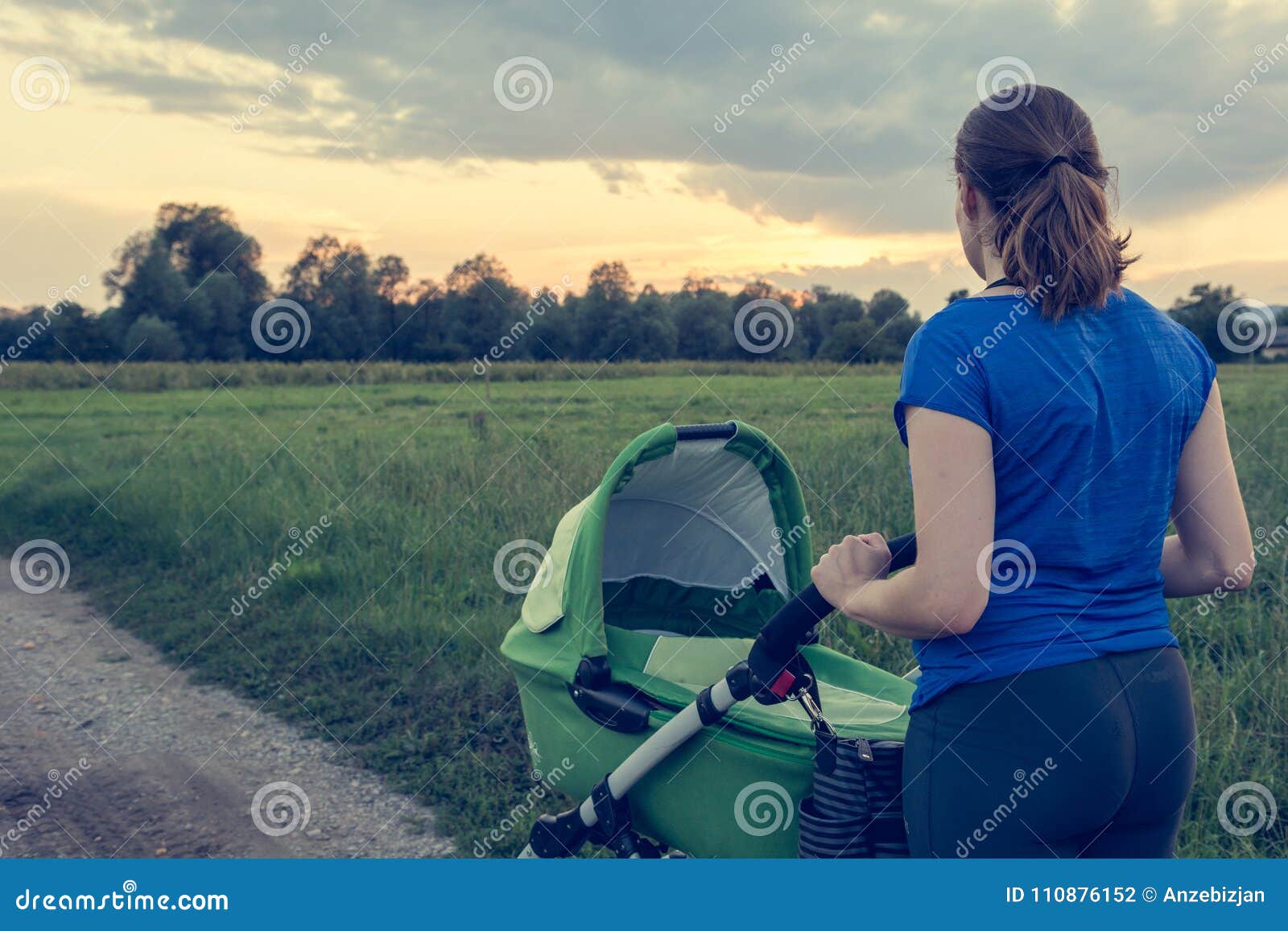 Active Mom Pushing a Stroller at Sunset. Stock Photo - Image of baby ...