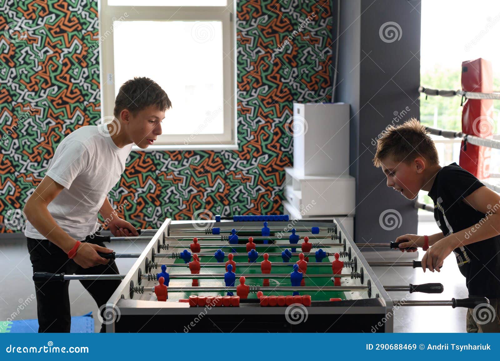 Active Recreation in the Game Room, Children Play Table Football. Stock ...