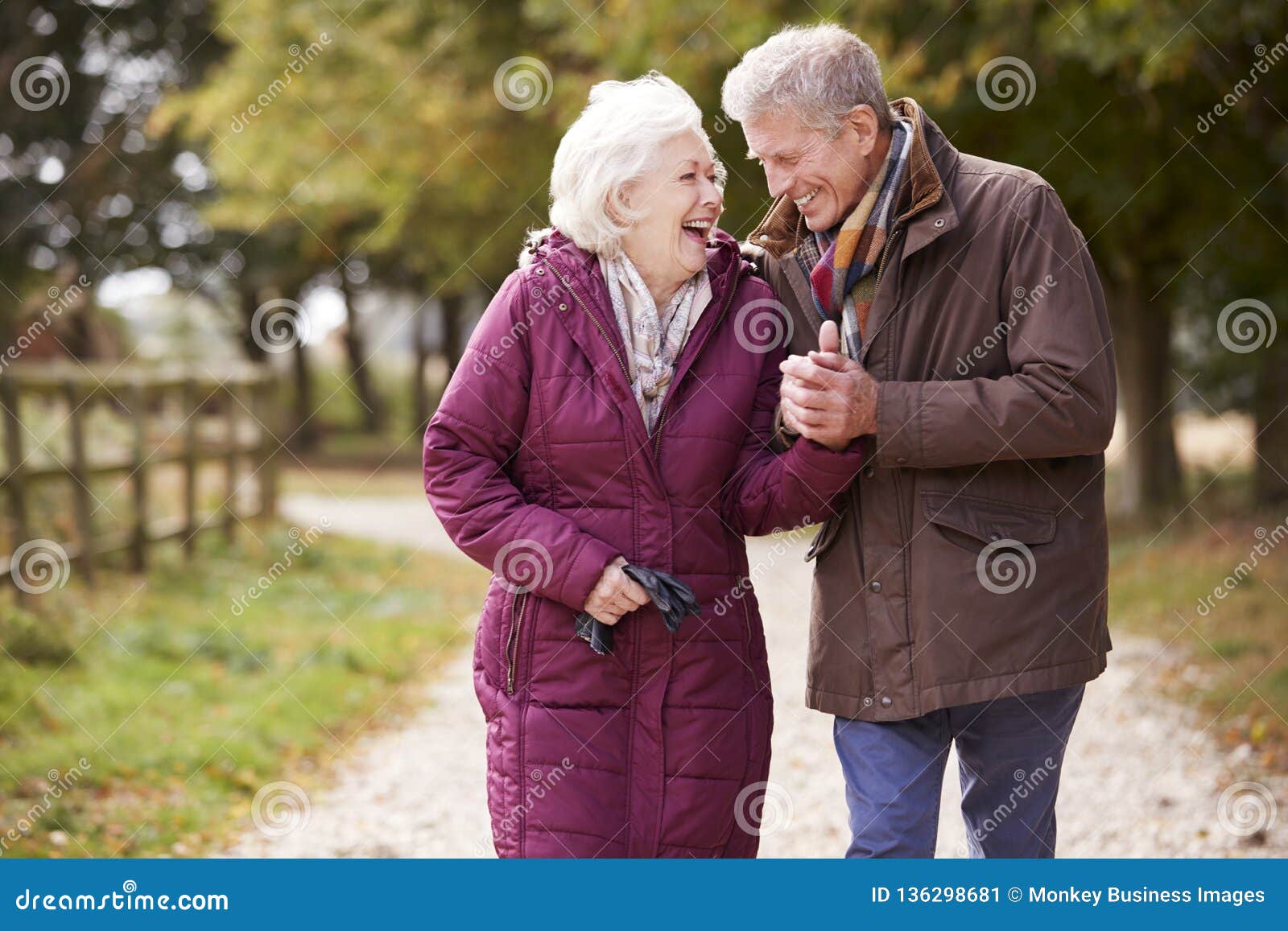 Active Senior Couple on Autumn Walk on Path through Countryside Stock ...