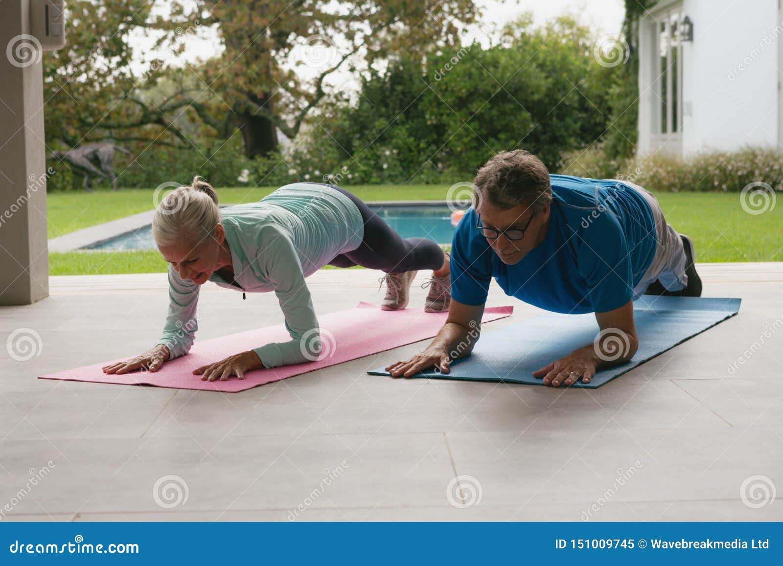 Active Senior Couple Doing Plank Exercise in the Porch at Home Stock ...