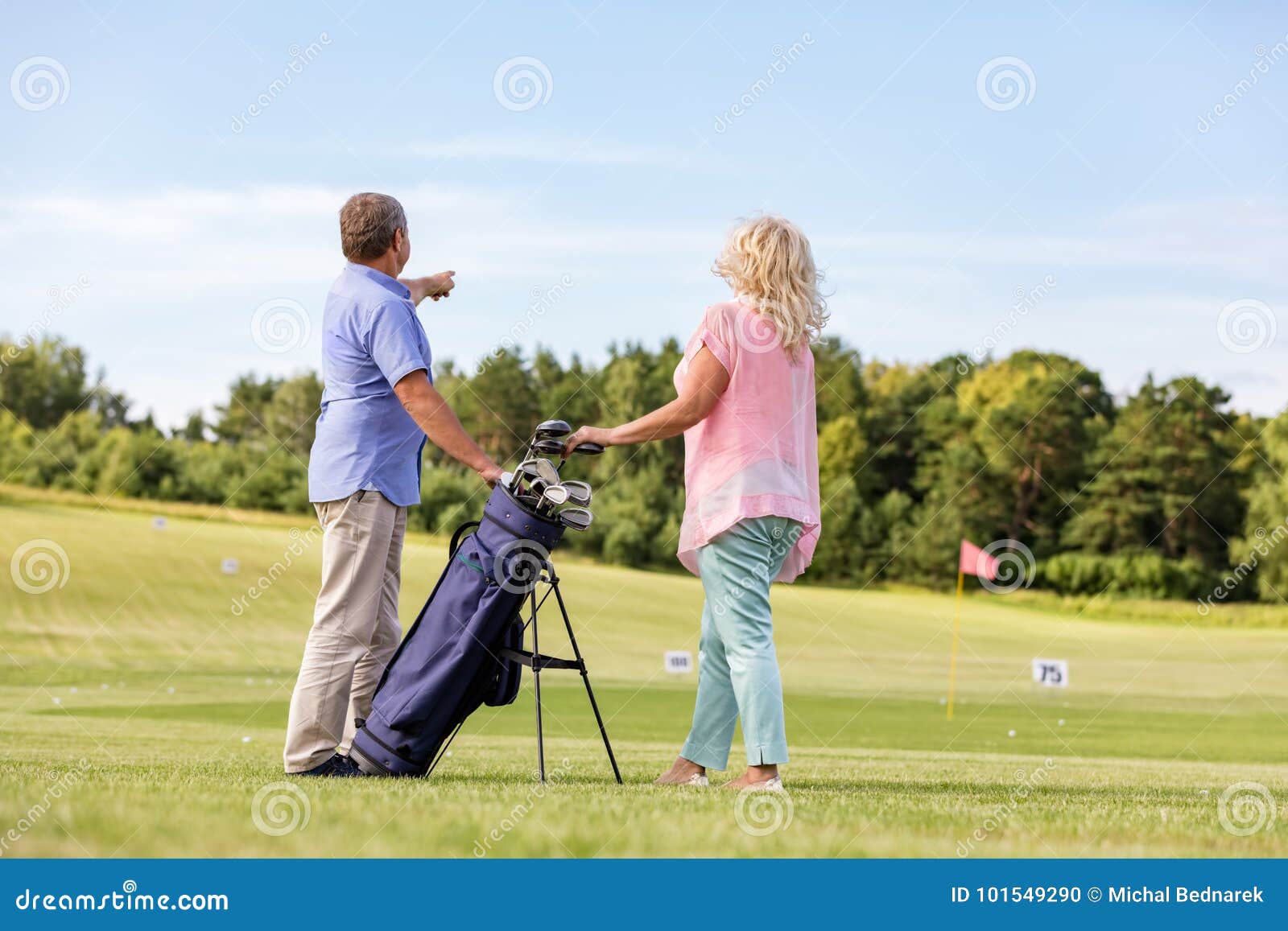 Active Senior Couple Playing Golf on a Course. Stock Photo - Image of ...