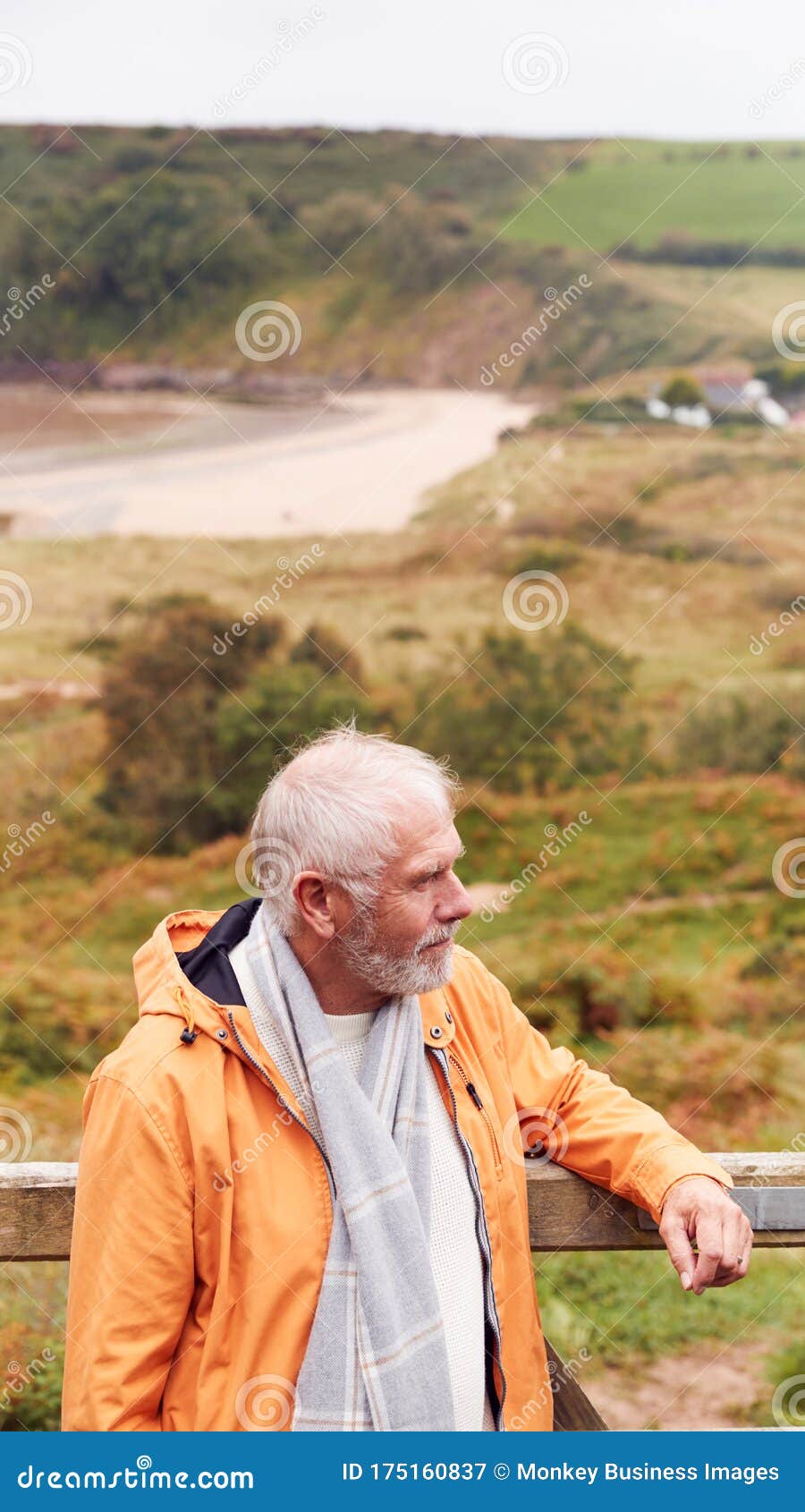 Active Senior Man Walking Along Coastal Path in Fall or Winter by Gate ...