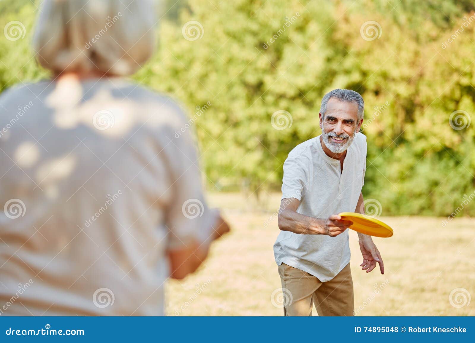 Active Seniors Playing with a Frisbee Stock Photo - Image of seniors ...