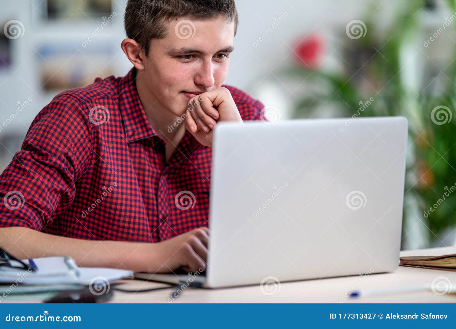 Active Teen with Headphones Listens To Lecture, Does in Notebook, Using ...