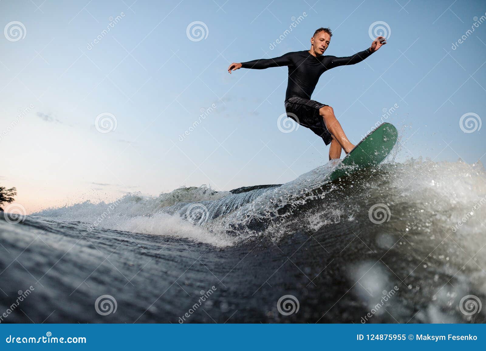 Active Wakesurfer Jumping on a Wake Board Down the River Stock Image ...
