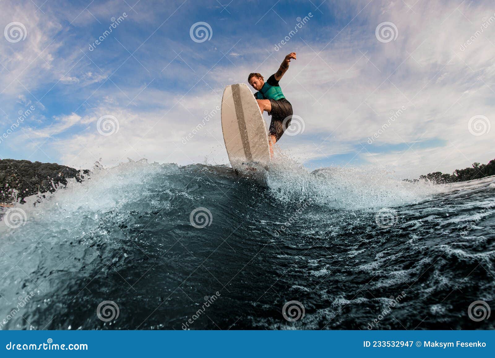 Active Wakesurfer Jumping on a Wake Board on Splashing River Wave ...