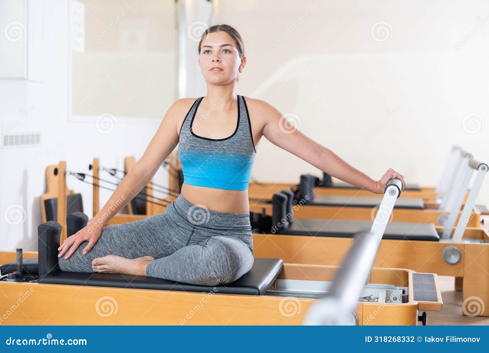 Active Woman Doing Pilates Exercises on Pilates Workout Machines Stock ...