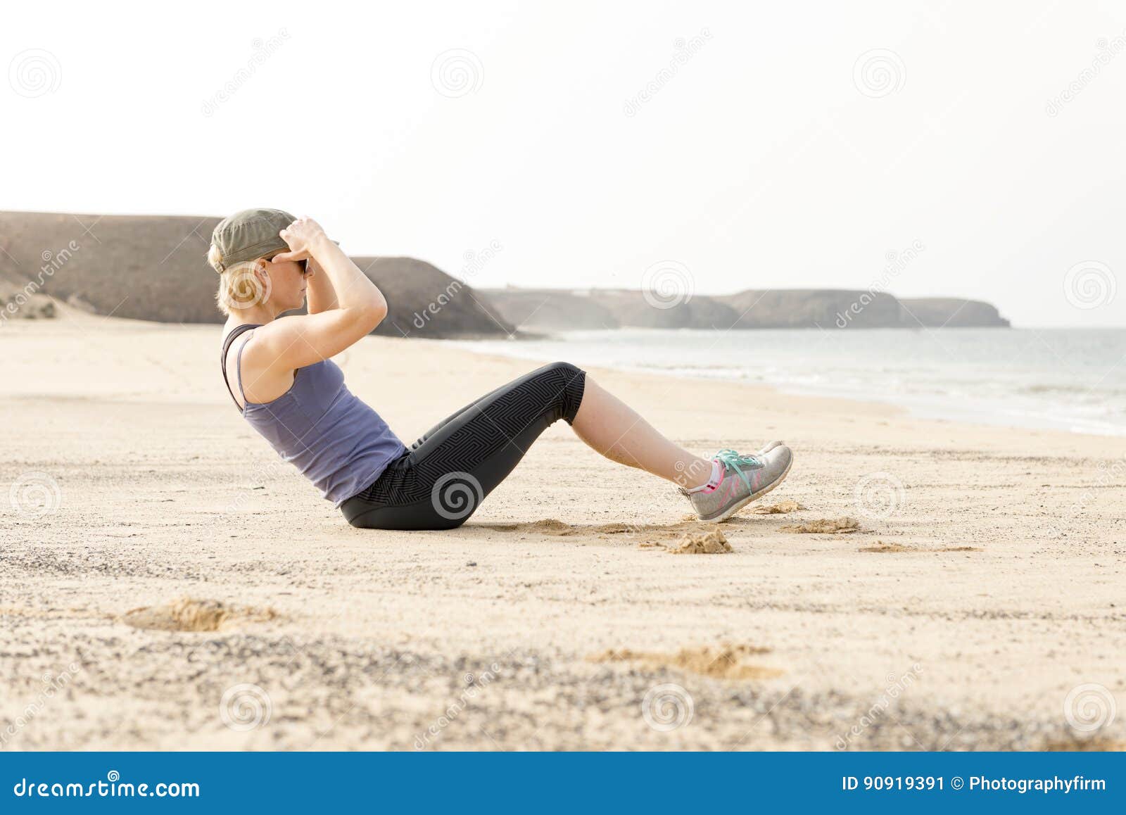 Active Woman Doing Sit-Ups by the Beach Stock Image - Image of athletic ...
