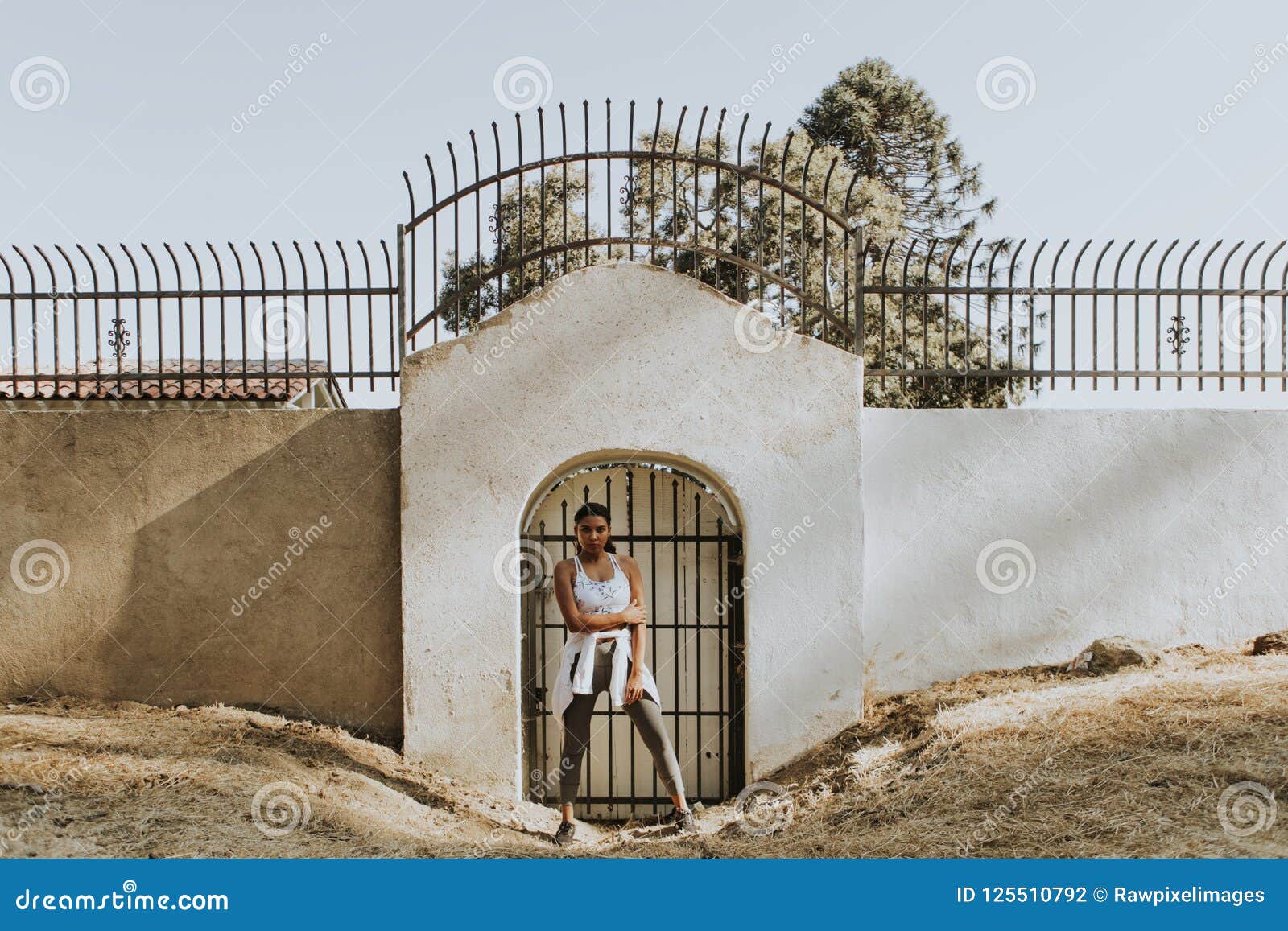 Active Woman Standing by a Gate Stock Photo - Image of resting, fence ...