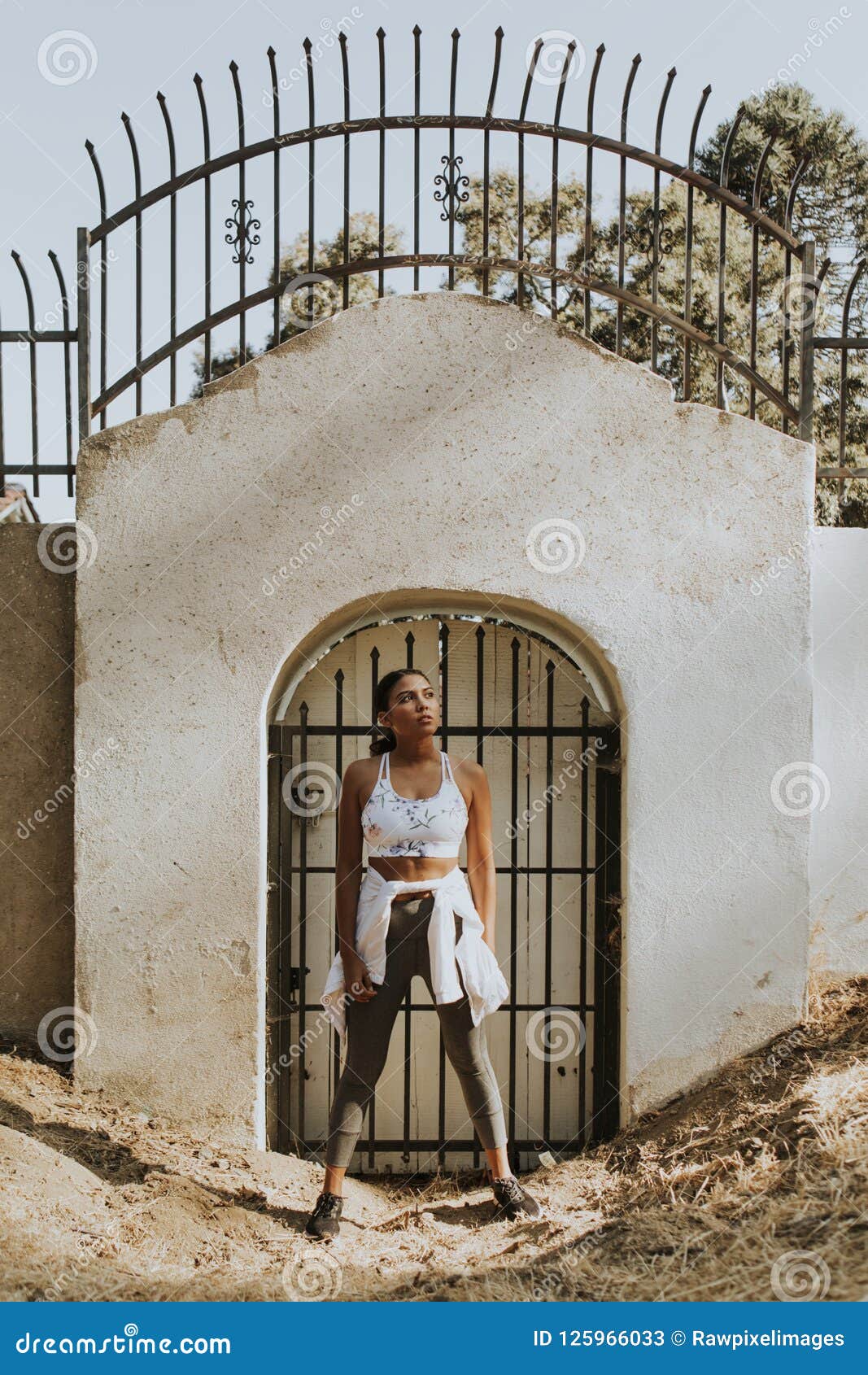 Active Woman Standing by a Gate Stock Image - Image of gate, park ...