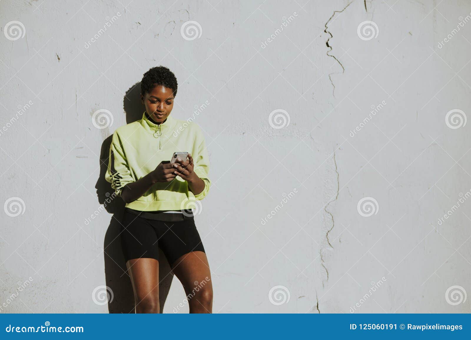 Active Woman Standing by a White Wall Stock Image - Image of online ...