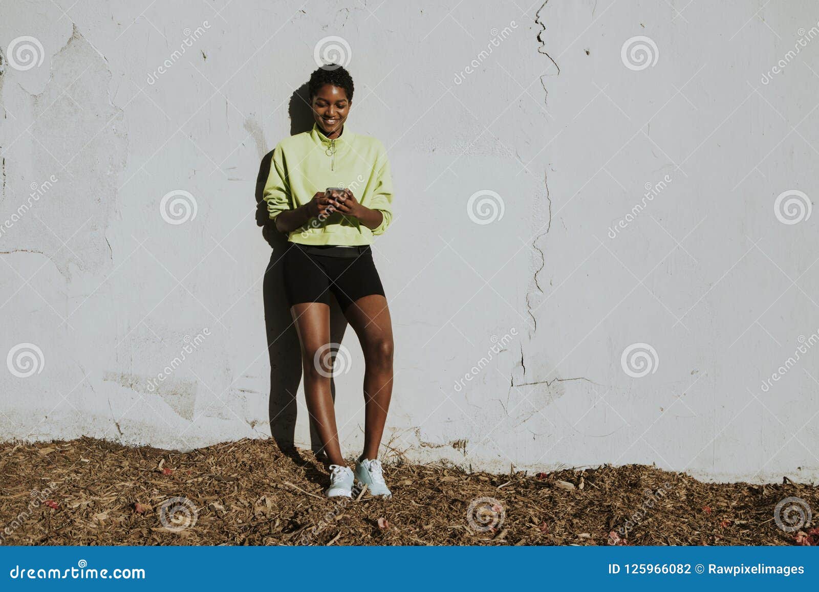 Active Woman Standing by a White Wall Stock Photo - Image of ...