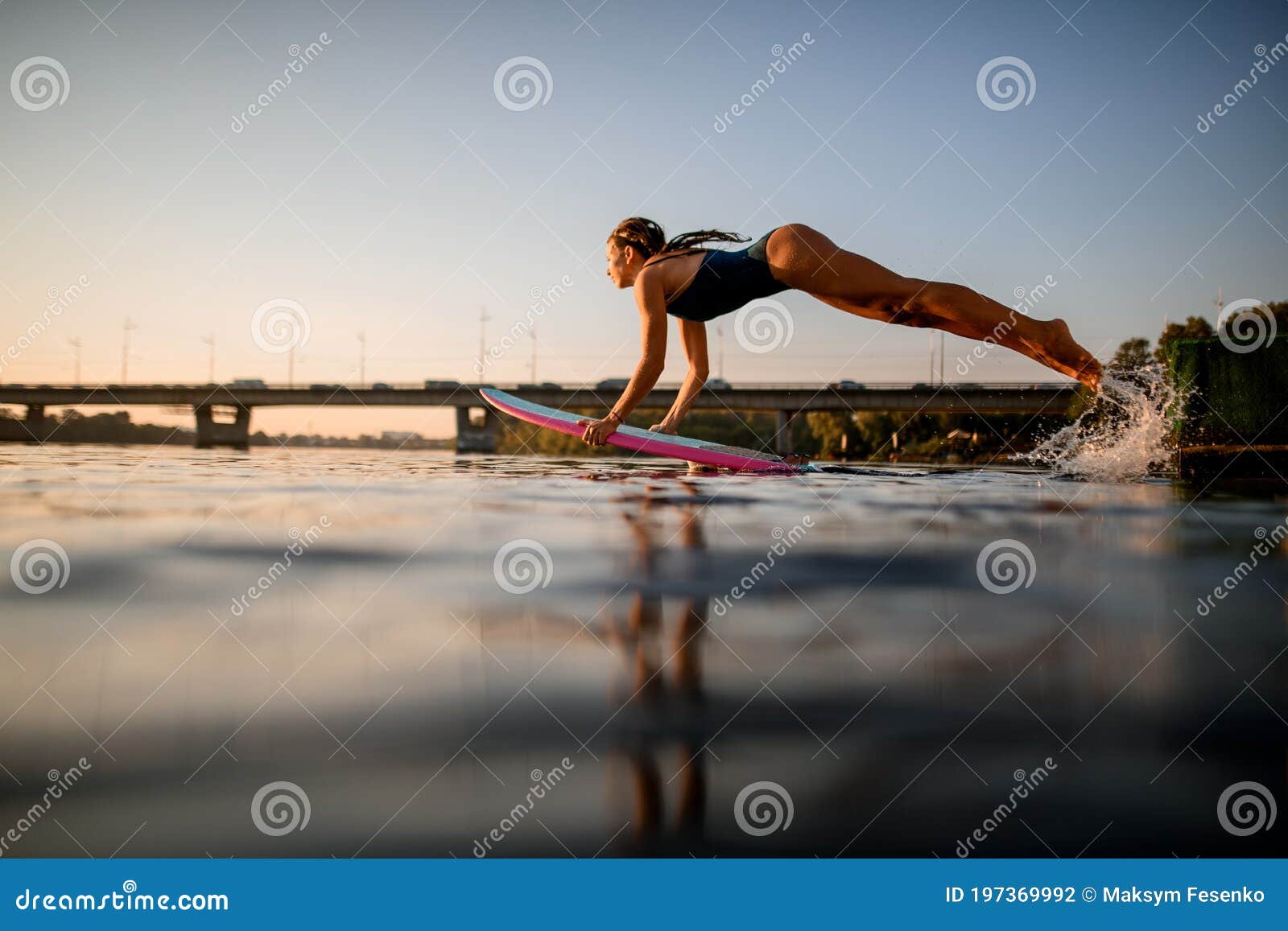 Active Woman With Surf Style Wakeboard In Her Hands Flies Over The