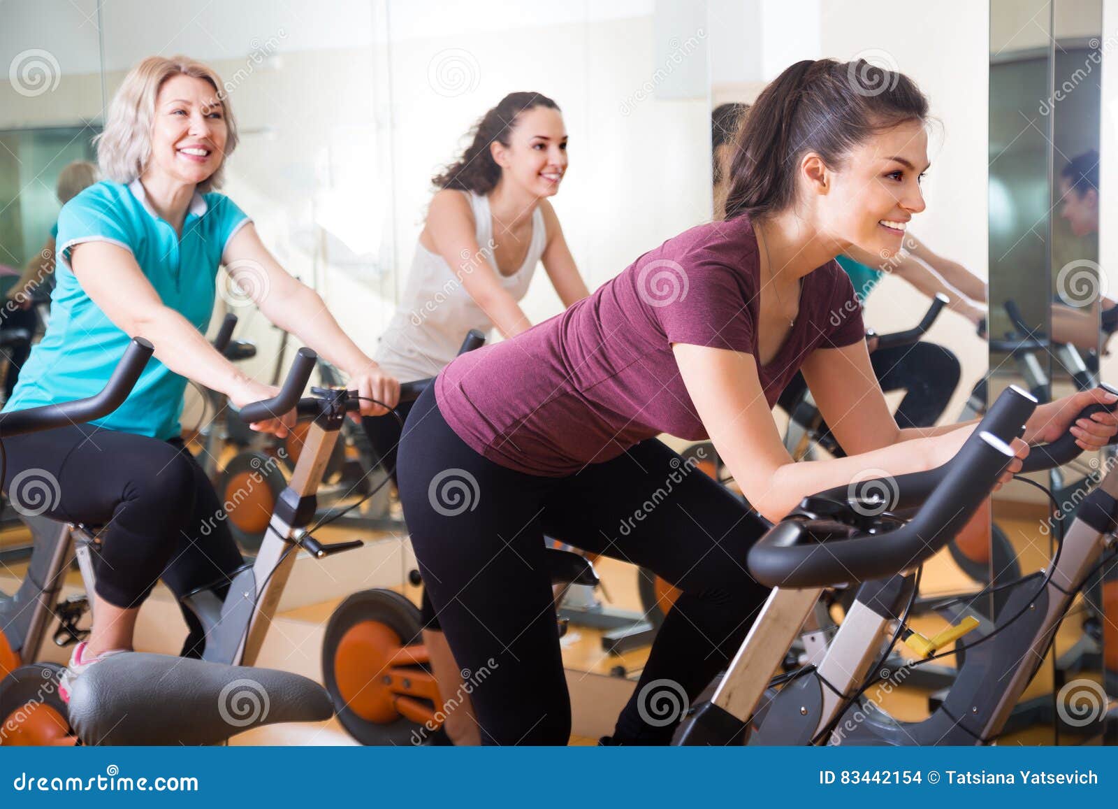 Active Women of Different Age Training on Exercise Bikes Stock Photo ...