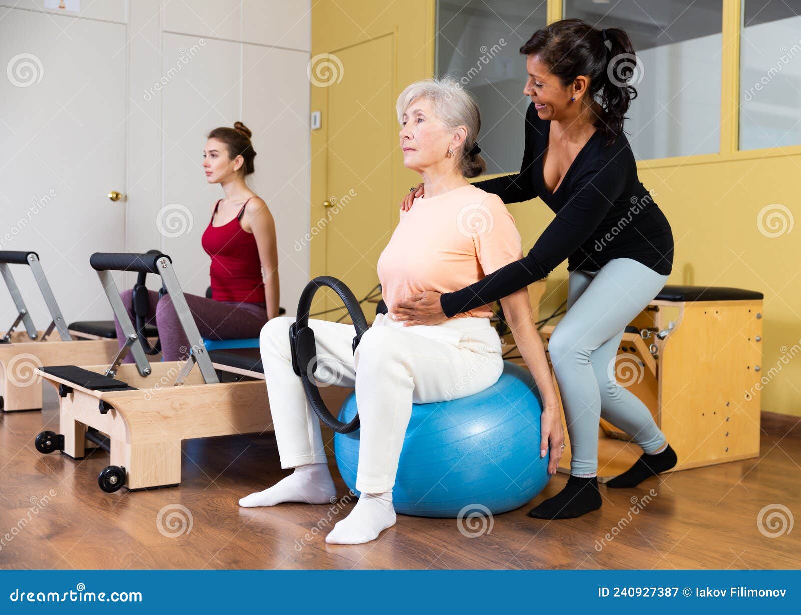 Active Women Perform Exercises With Fitness Balls And Pilates Rings