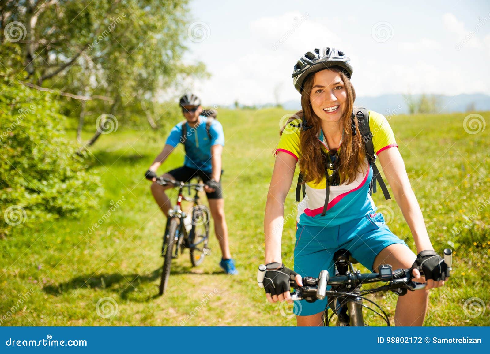 ACTIVE Young Couple Biking on a Forest Road in Mountain on a Spring Day ...
