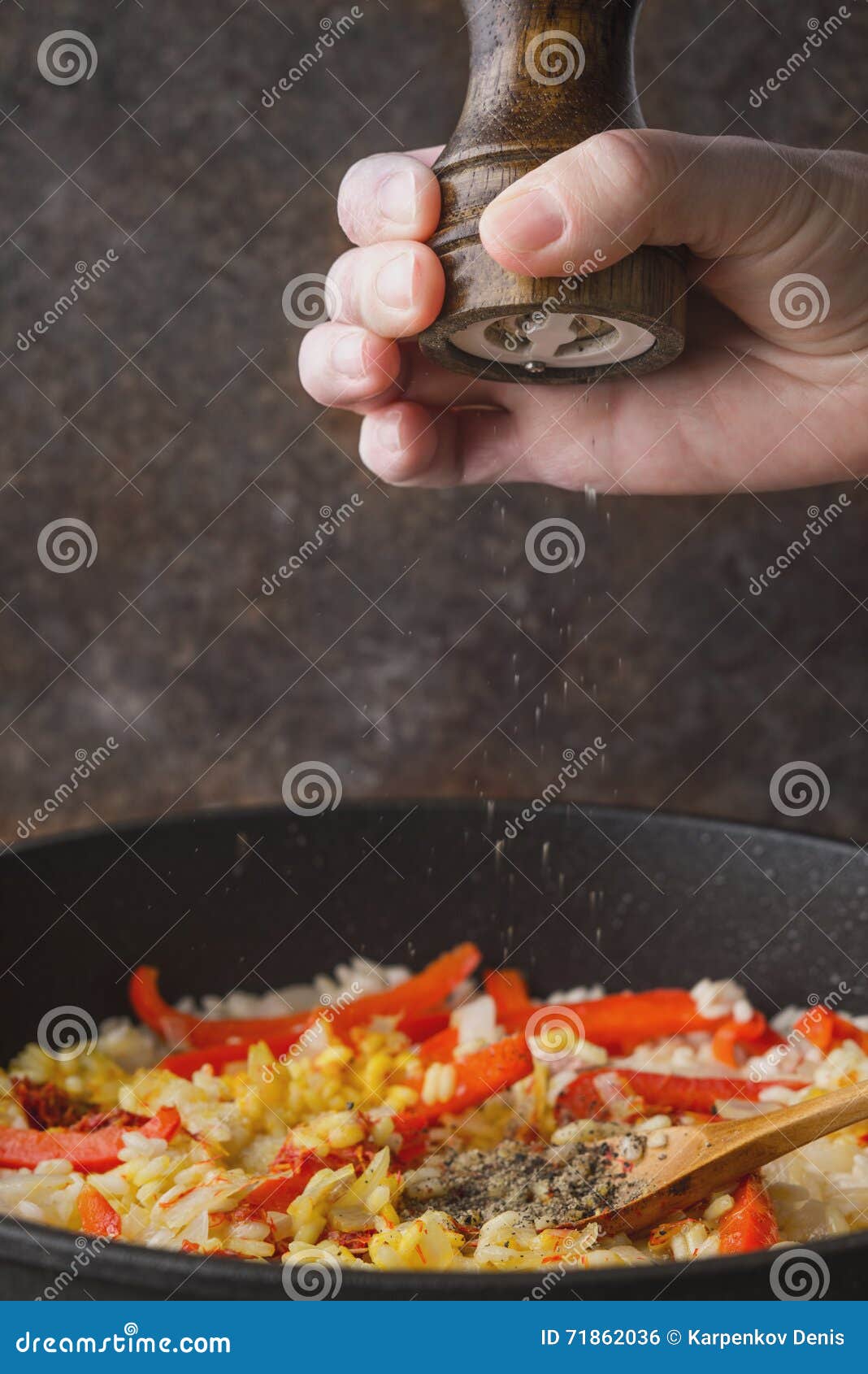 Adding Black Pepper in the Pan with Rice and Bell Pepper Vertical Stock ...