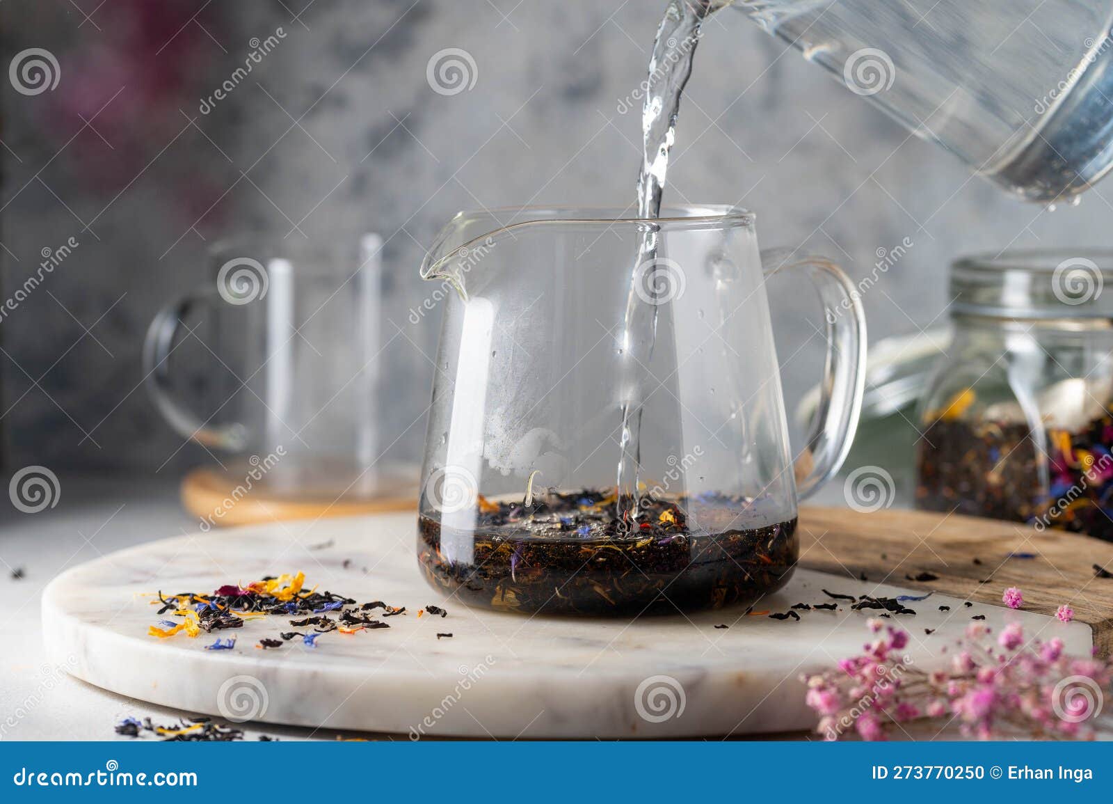 Adding Hot Water To Glass Tea Pot with Loose Black Leaf Tea. Making Tea ...