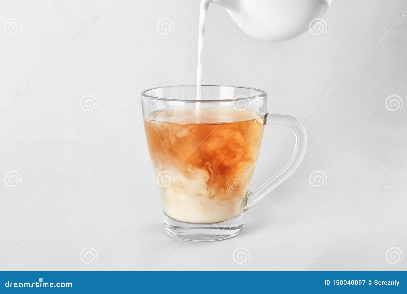 Adding Milk To Delicious Tea on Light Background Stock Image - Image of ...