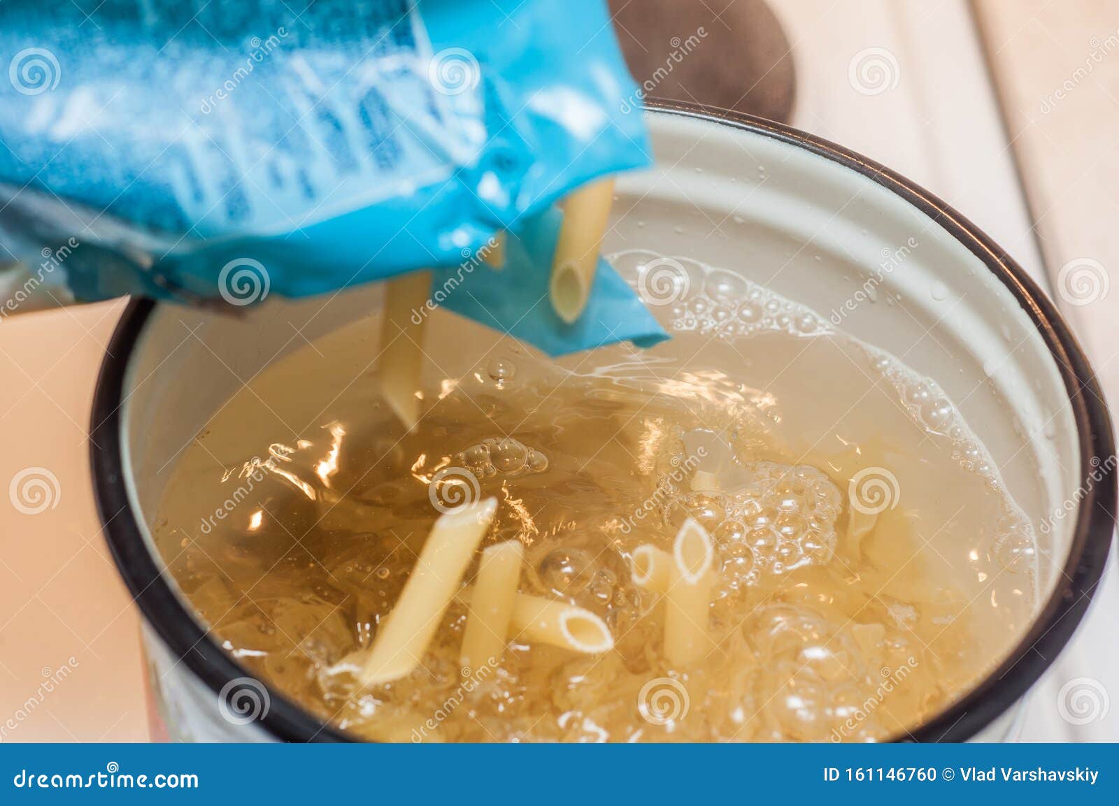 Adding Pasta To Boiling Water from the Packaging Stock Photo - Image of ...