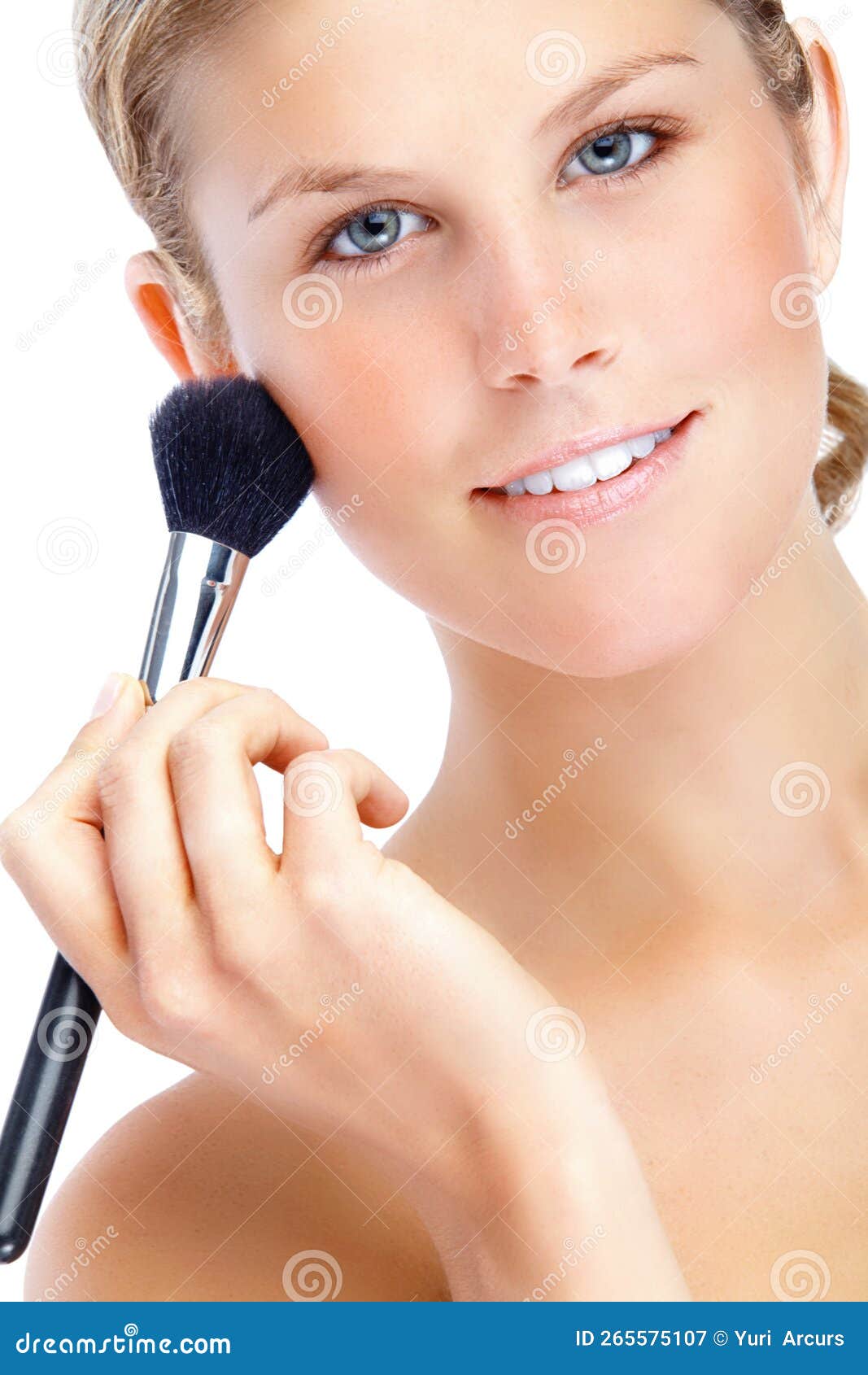 Adding a Shade of Pink. Attractive Young Woman Applying Blusher To Her ...