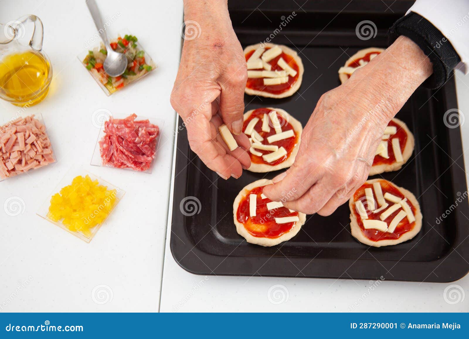 Adding Toppings To the Mini Pizzas. Adding Cheese Stock Image - Image ...