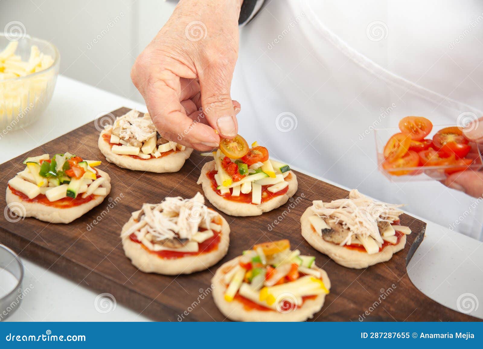 Adding Toppings To the Mini Pizzas. Delicious Homemade Mini Pizzas ...