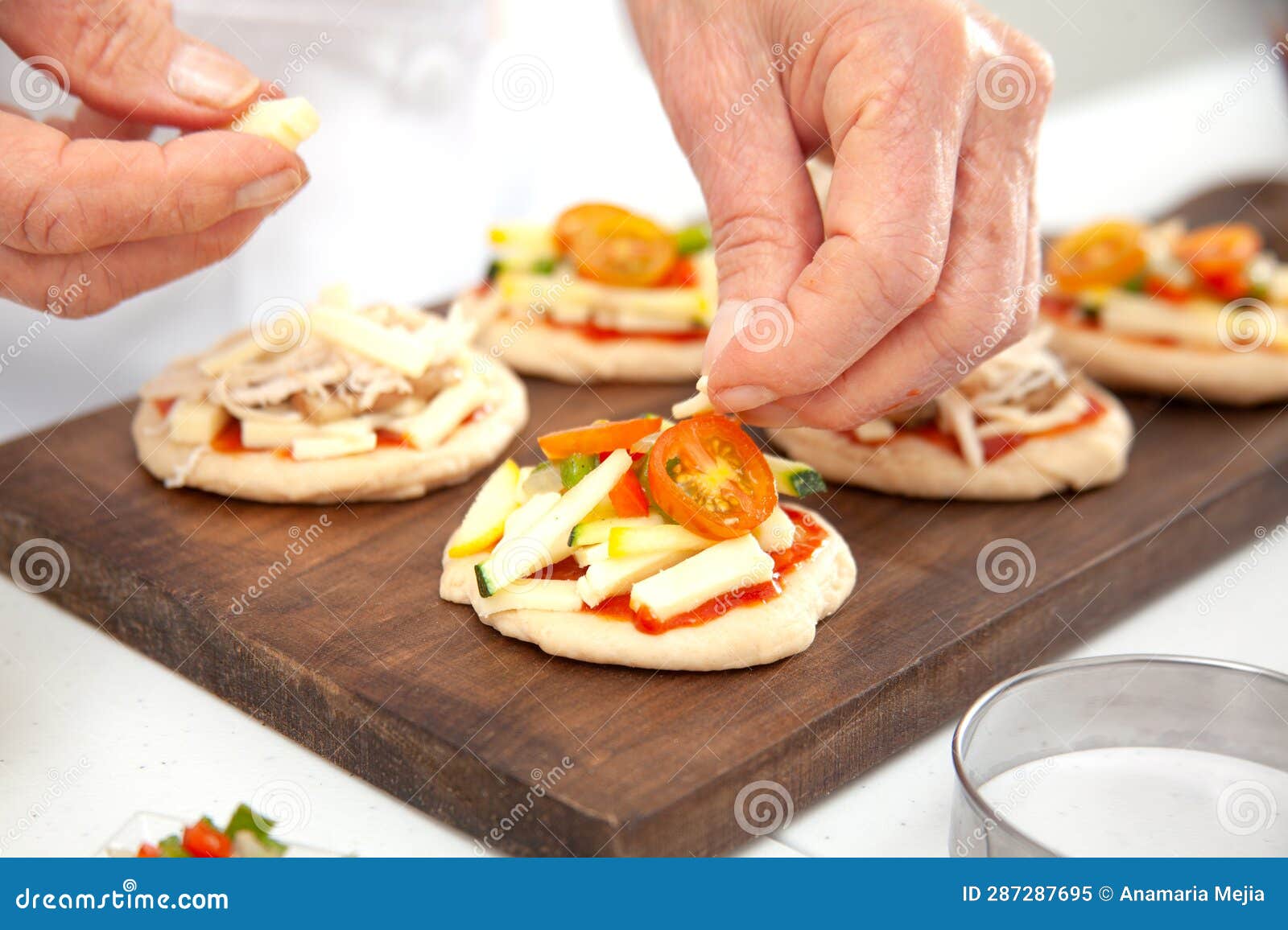 Adding Toppings To the Mini Pizzas. Delicious Homemade Mini Pizzas ...
