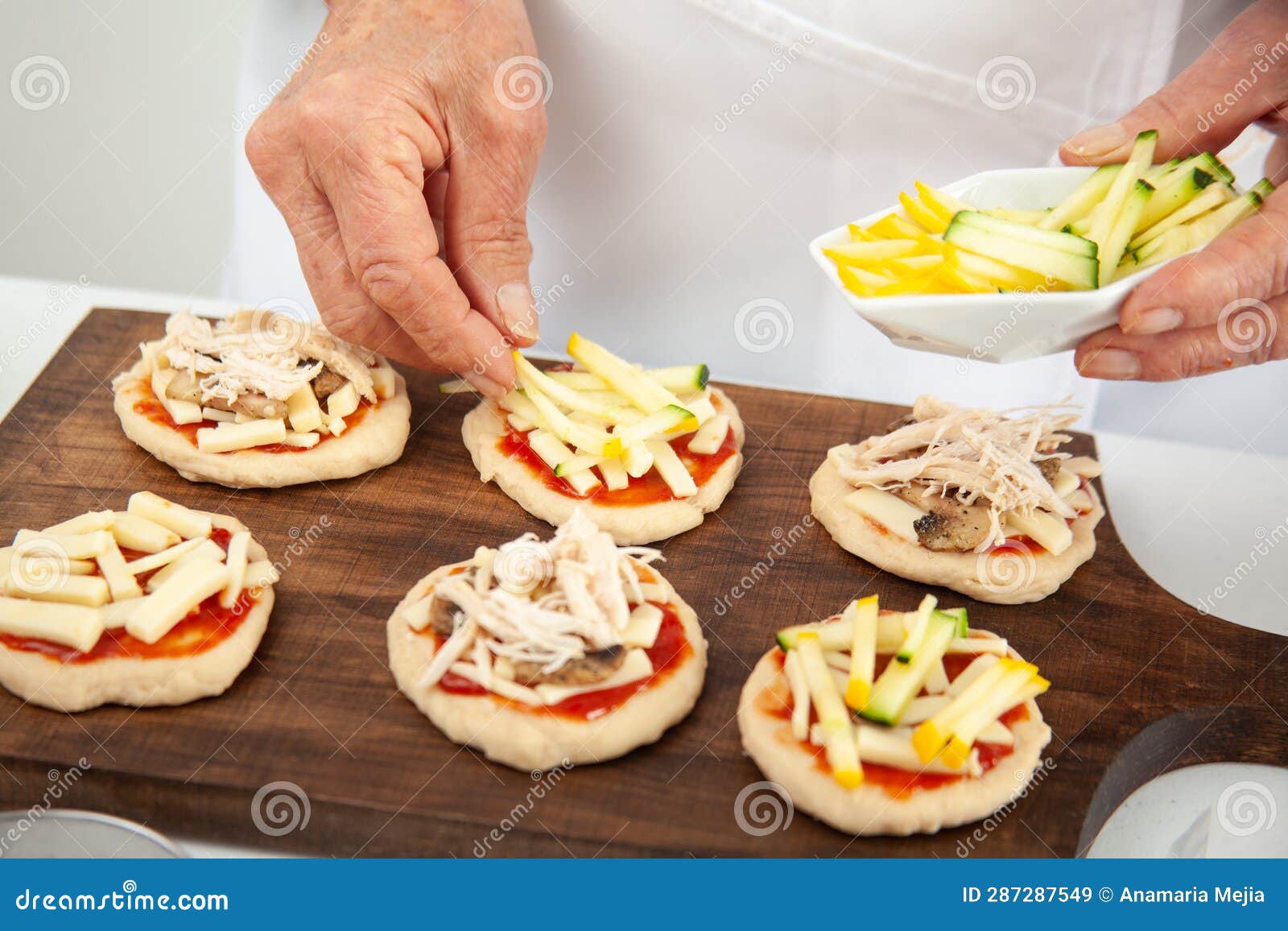 Adding Toppings To the Mini Pizzas. Adding Vegetables Stock Image ...
