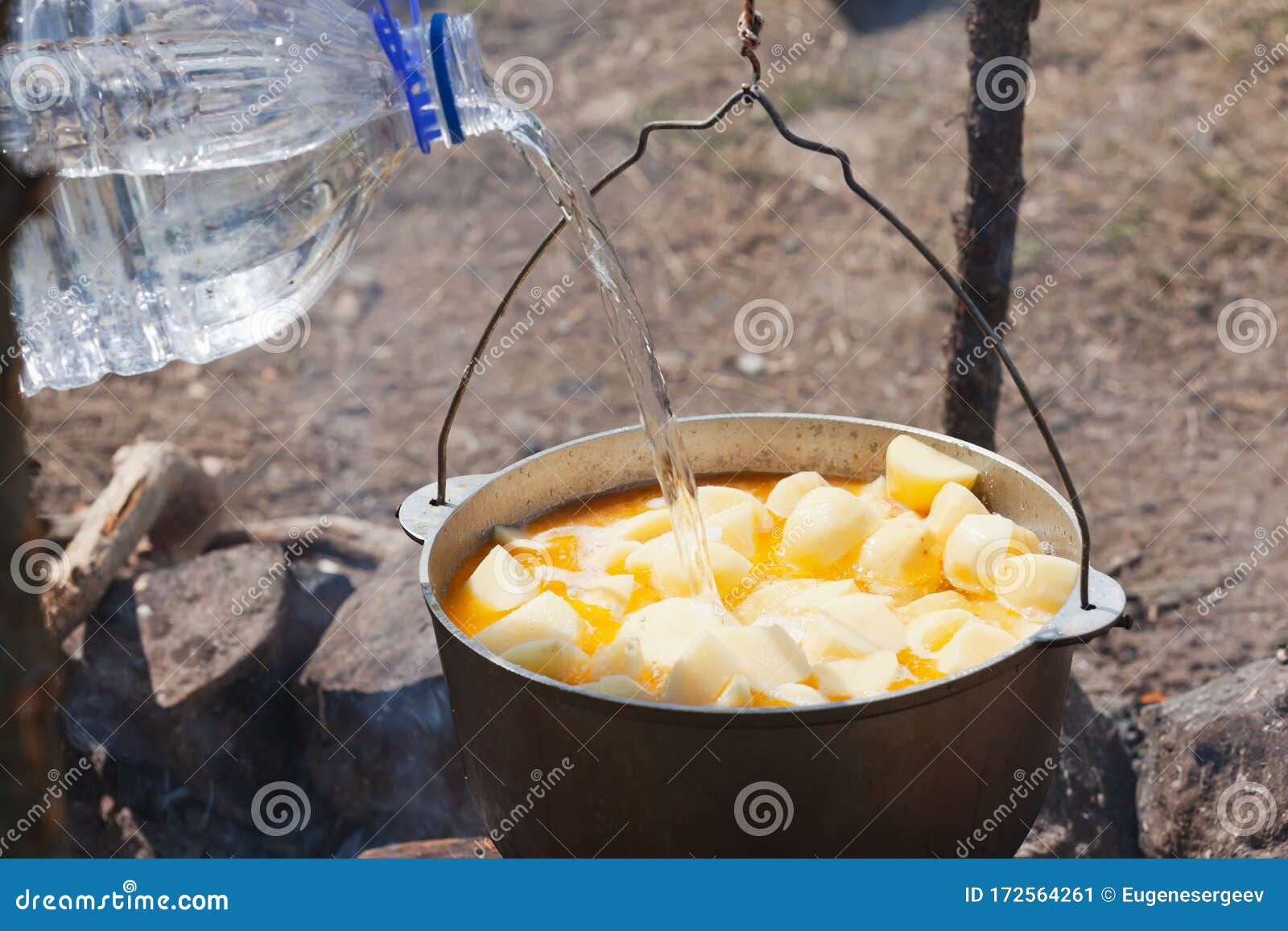 Adding Water from Big Plastic Bottle in Black Cauldron Stock Image ...