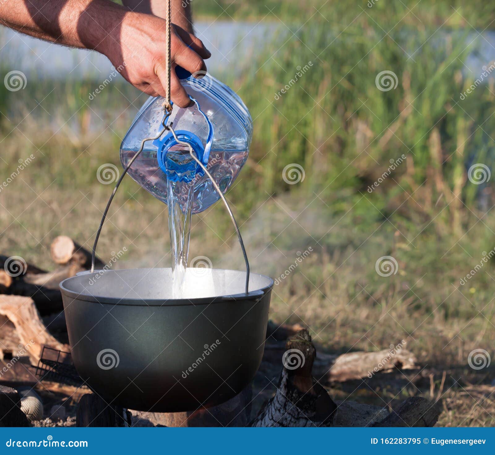 Adding Water from a Bottle in Cauldron Stock Image - Image of cauldron ...