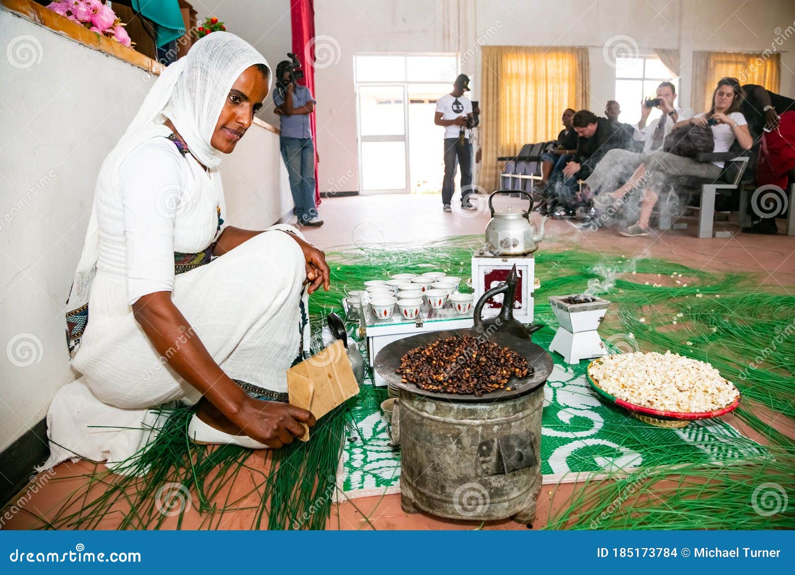African Woman Roasting Beans On A Frying Pan For Traditional Coffee