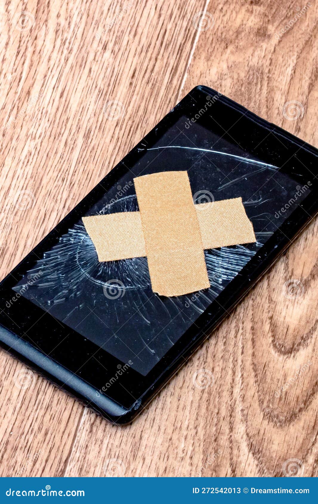 Adhesive Plaster on a Broken Phone Display on Wooden Table Stock Image ...