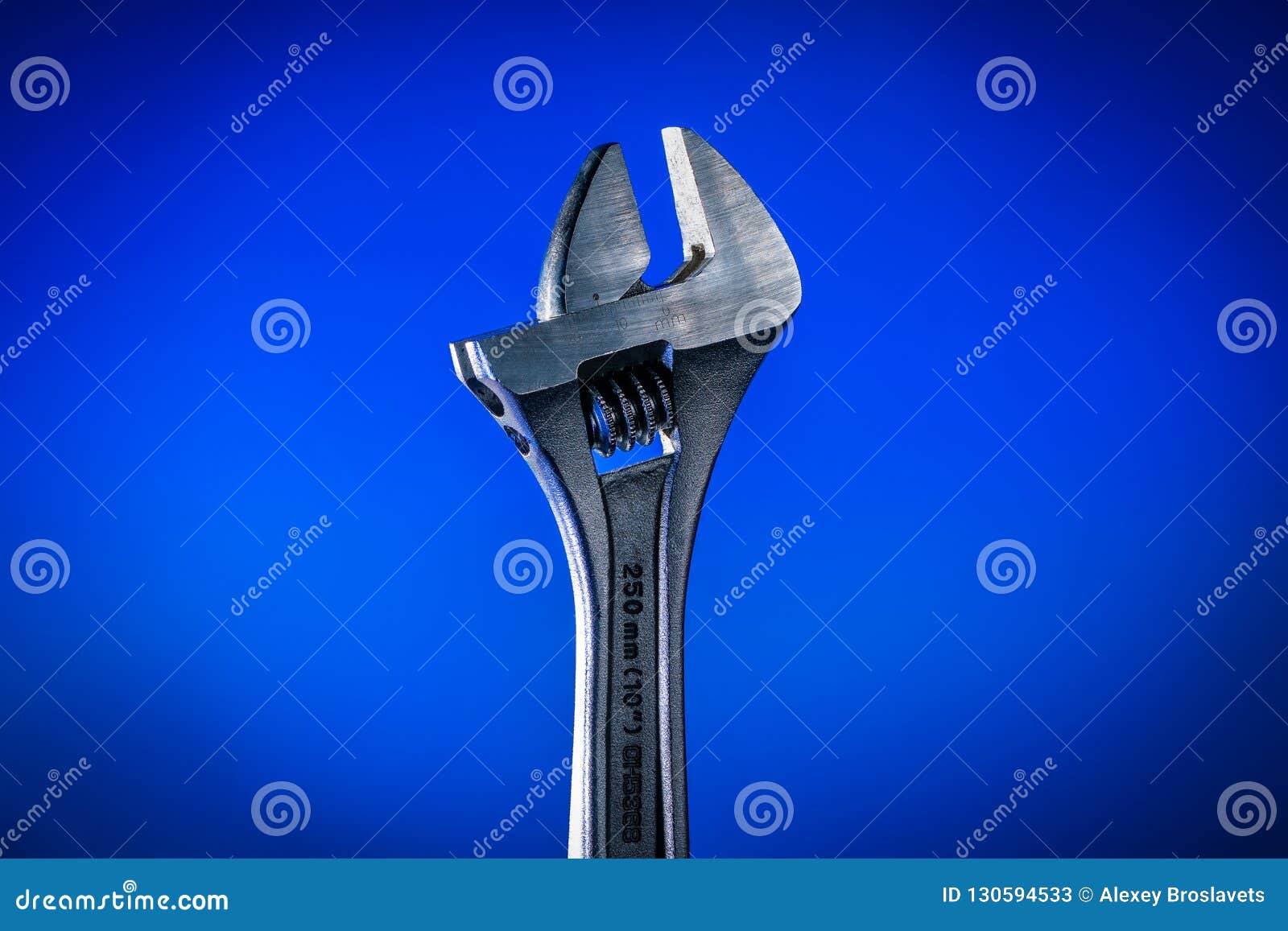Adjustable wrench on blue stock image. Image of close - 130594533