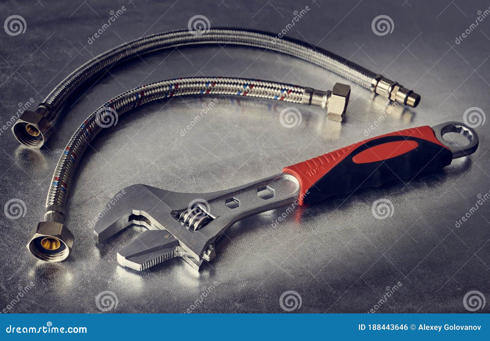 Adjustable Wrench and Flexible Connecting Hoses on Silver Surface Stock ...