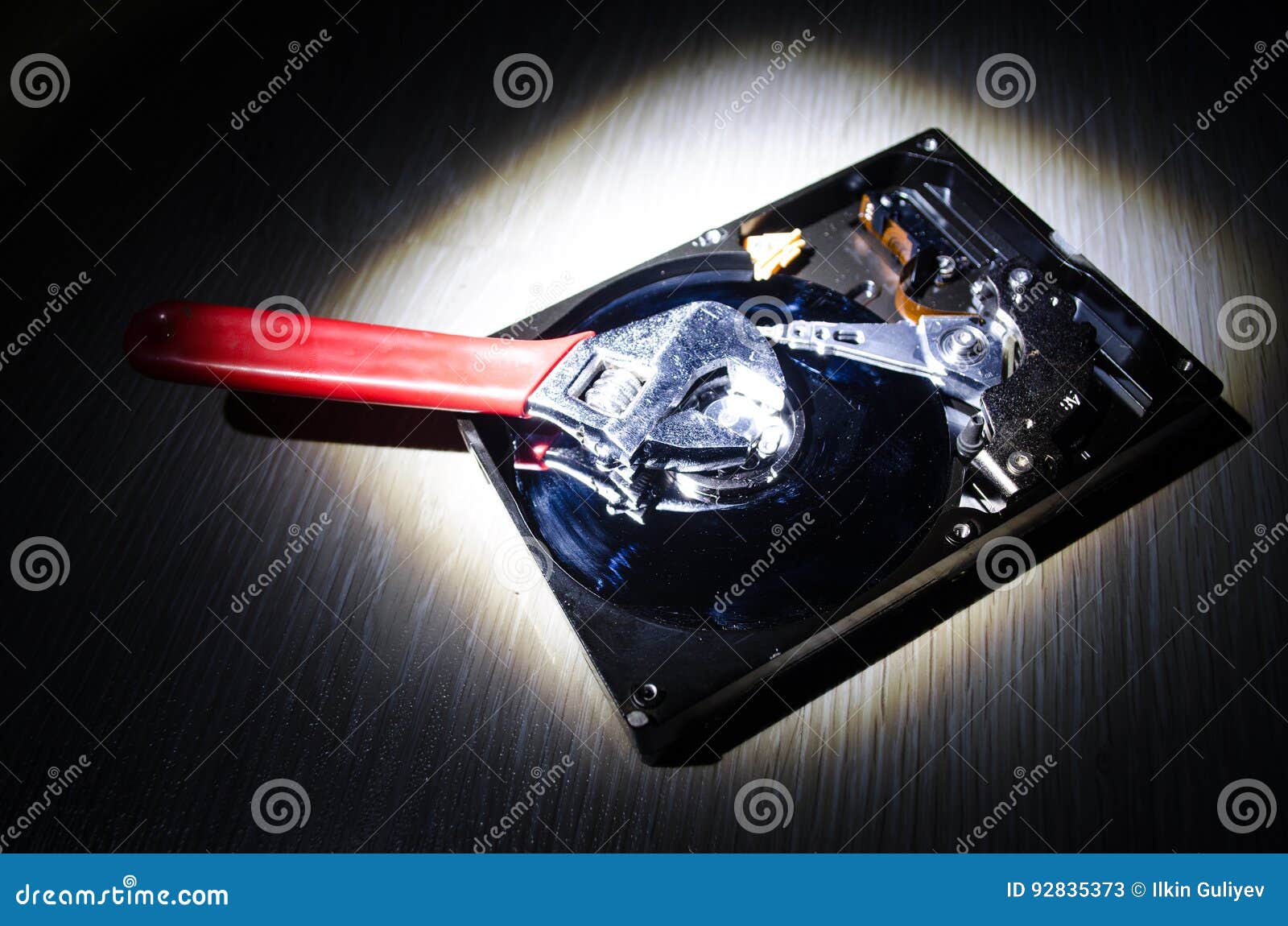 Adjustable Wrench Turn Off a Hard Disk. on a Dark Background. Computer ...