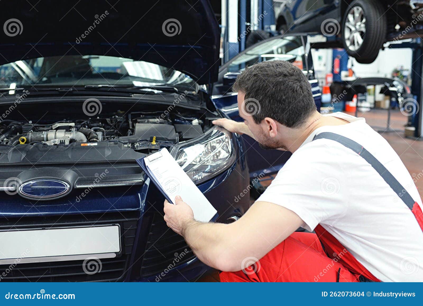 Adjusting the Headlights on the Car by Mechanics in a Garage Stock ...