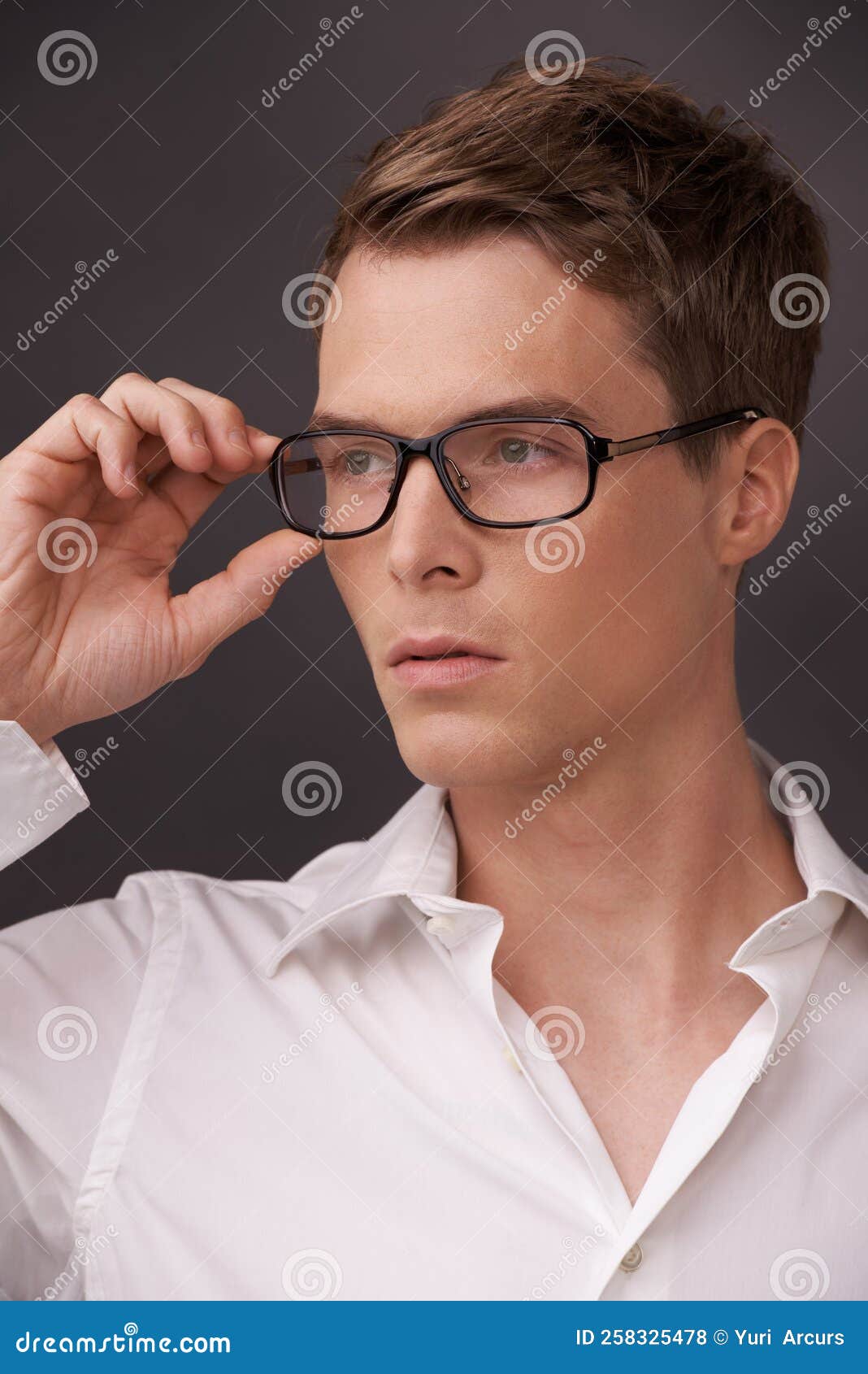 Adjusting His Spectacles. Closeup of a Handsome Young Man Touching the ...