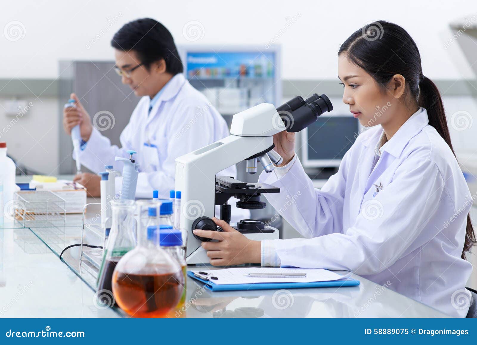 Adjusting microscope stock image. Image of chemist, asian - 58889075
