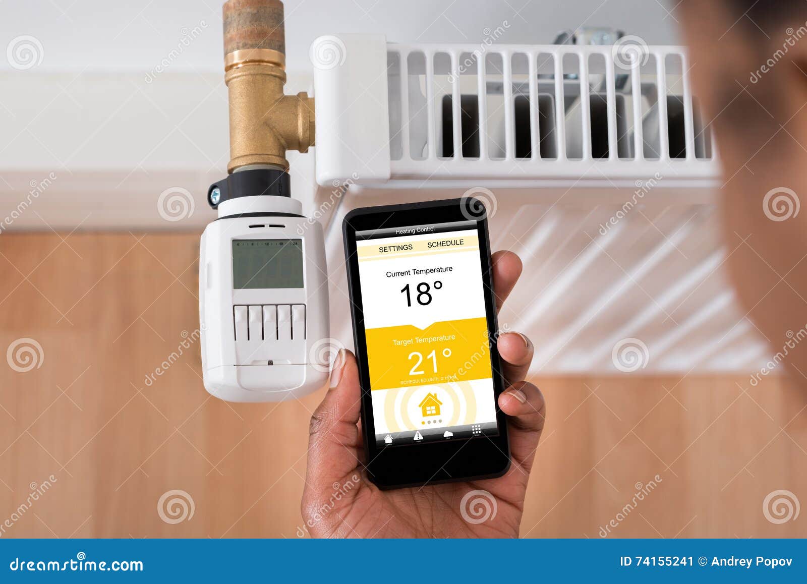 Adjusting Temperature on Thermostat Using Cellphone Stock Image - Image ...