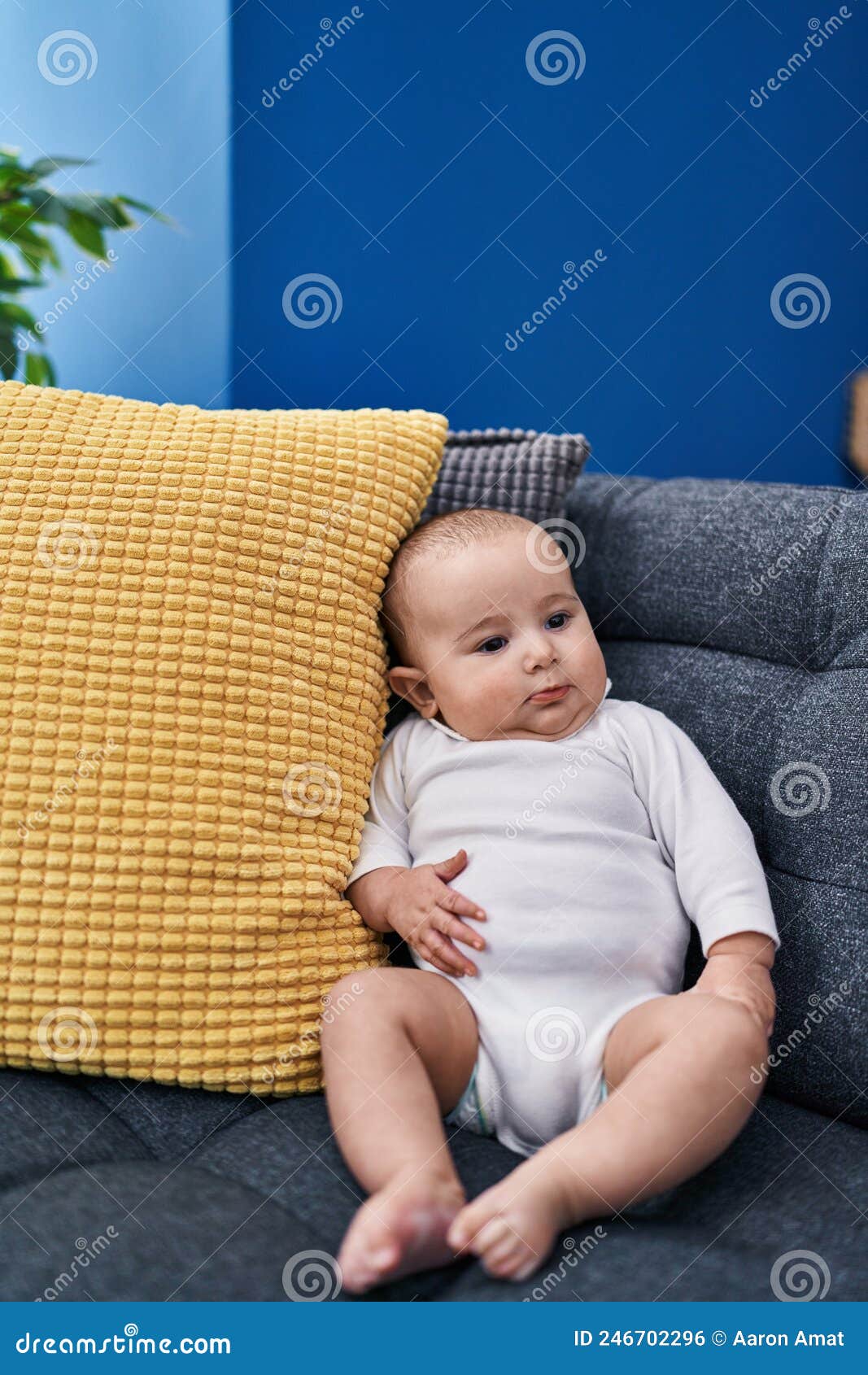 Adorable Baby Relaxed Sitting on Sofa at Home Stock Photo - Image of ...