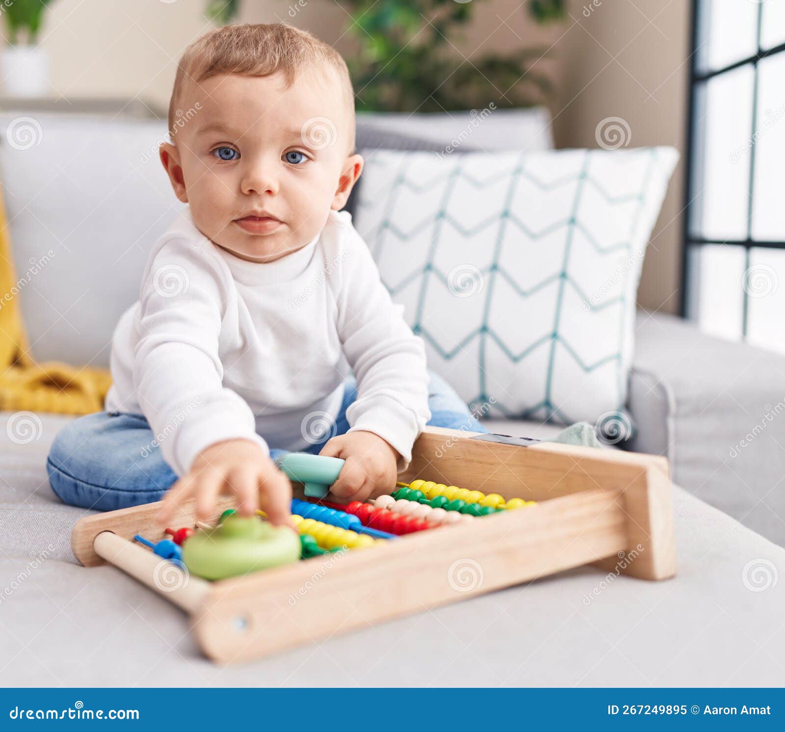 Adorable Blond Toddler Playing with Abacus Sitting on Sofa at Home ...
