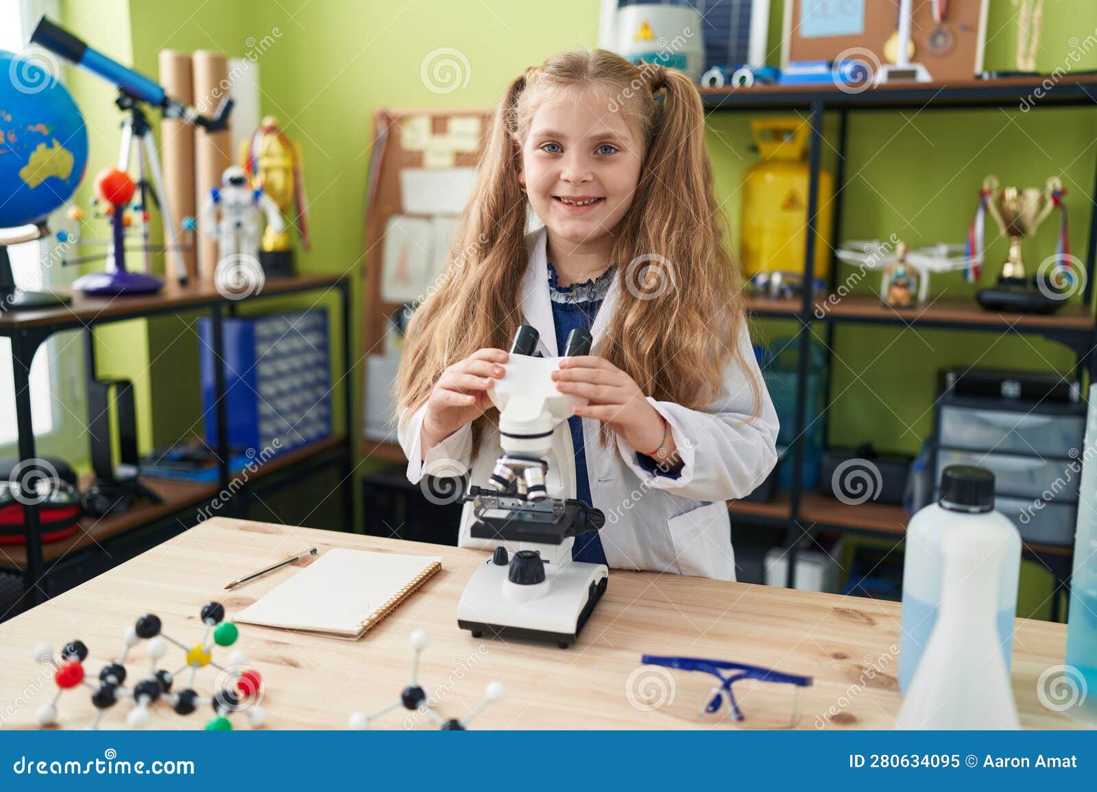 Adorable Blonde Girl Student Smiling Confident Using Microscope at ...