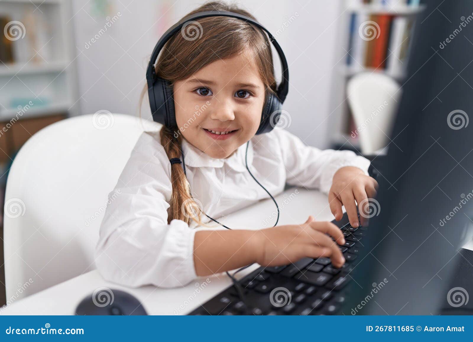 Adorable Blonde Girl Student Using Computer Sitting on Table at ...