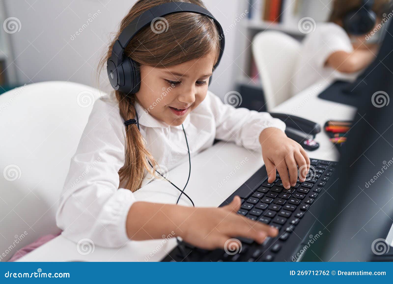 Adorable Blonde Girl Student Using Computer Sitting on Table at ...