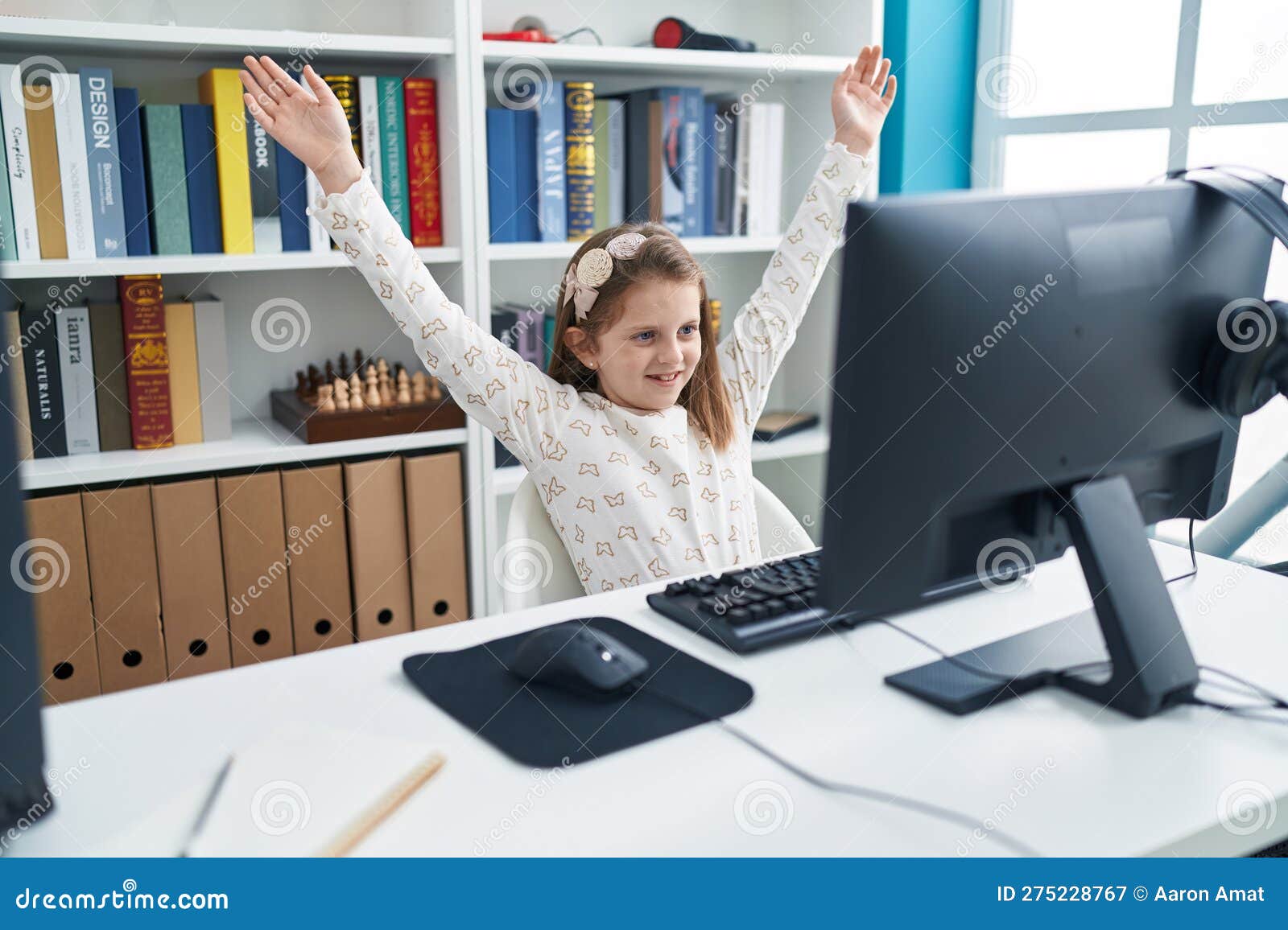 Adorable Blonde Girl Student Using Computer with Winner Expression at ...
